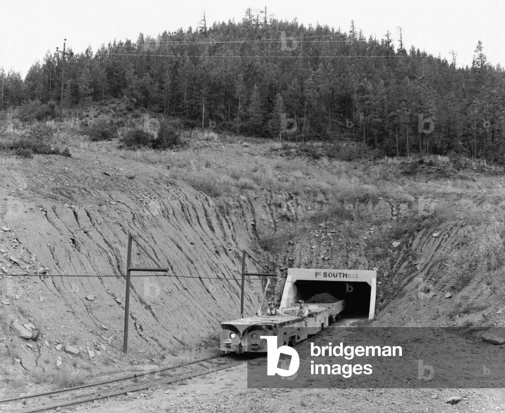 Image of Train coming out from a tunnel of an iron mine,