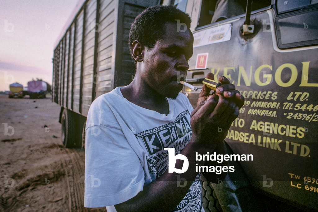 Image of Kenyan Truck Driver Smoking at a Truck Stop (photo) by ...