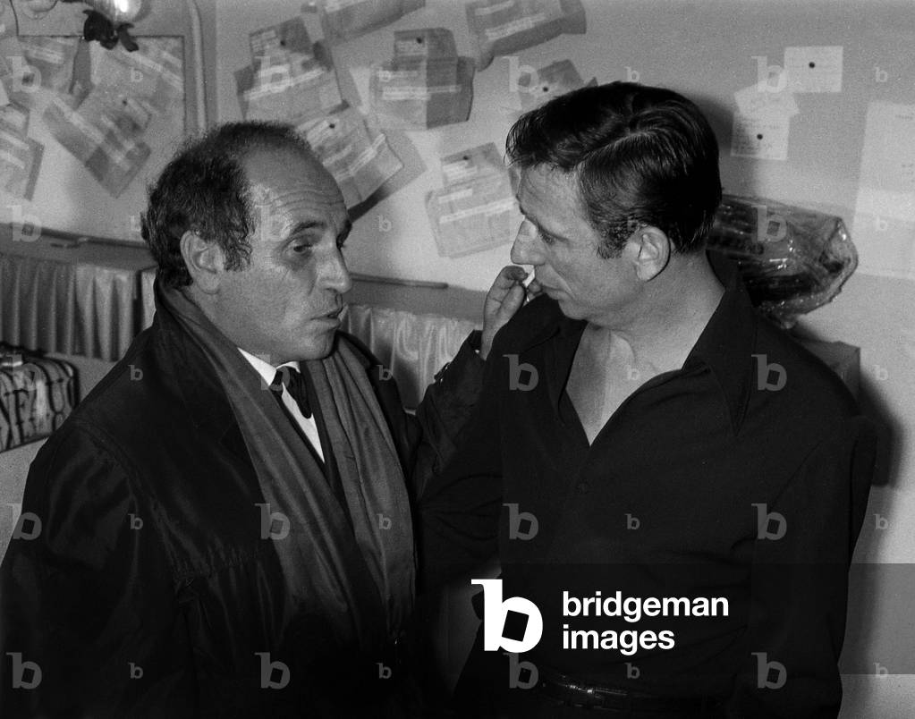 Image of Leo Ferre congratulating Yves Montand after his show in Paris,