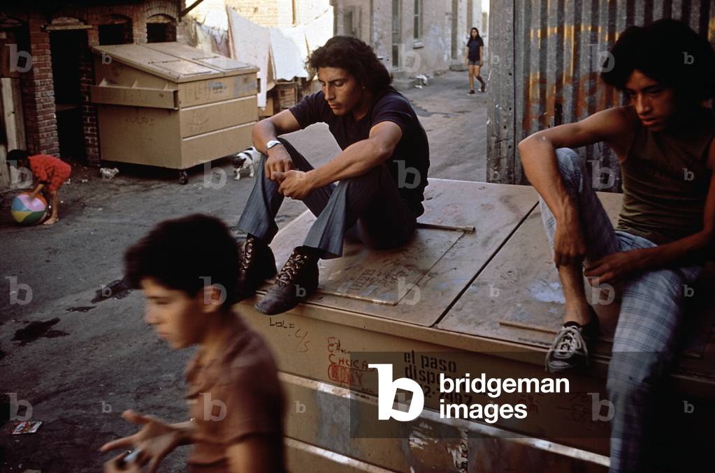 Image of 1970s Americ. Three young chicano men in the barrio area