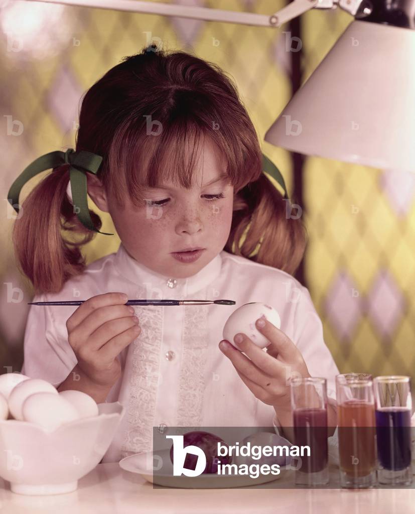 Image of Close-up of a girl coloring eggs for Easter