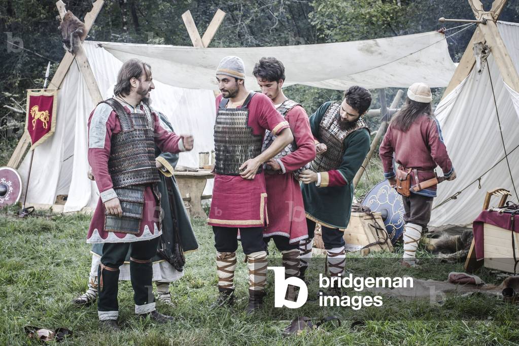 Image of Historical reenactment: Warriors putting on armor in Langobard ...