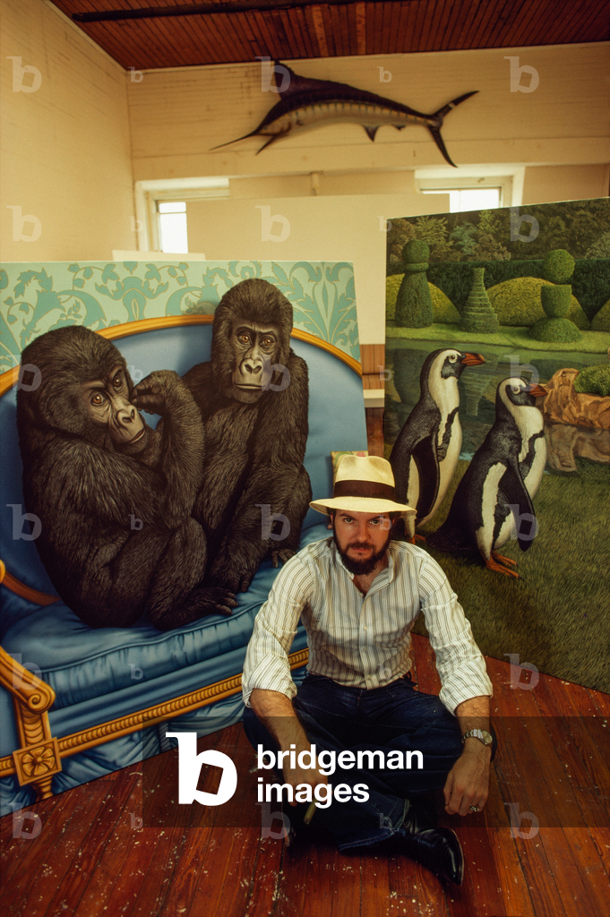 Image of A leading local artist poses beside his paintings of animal by ...