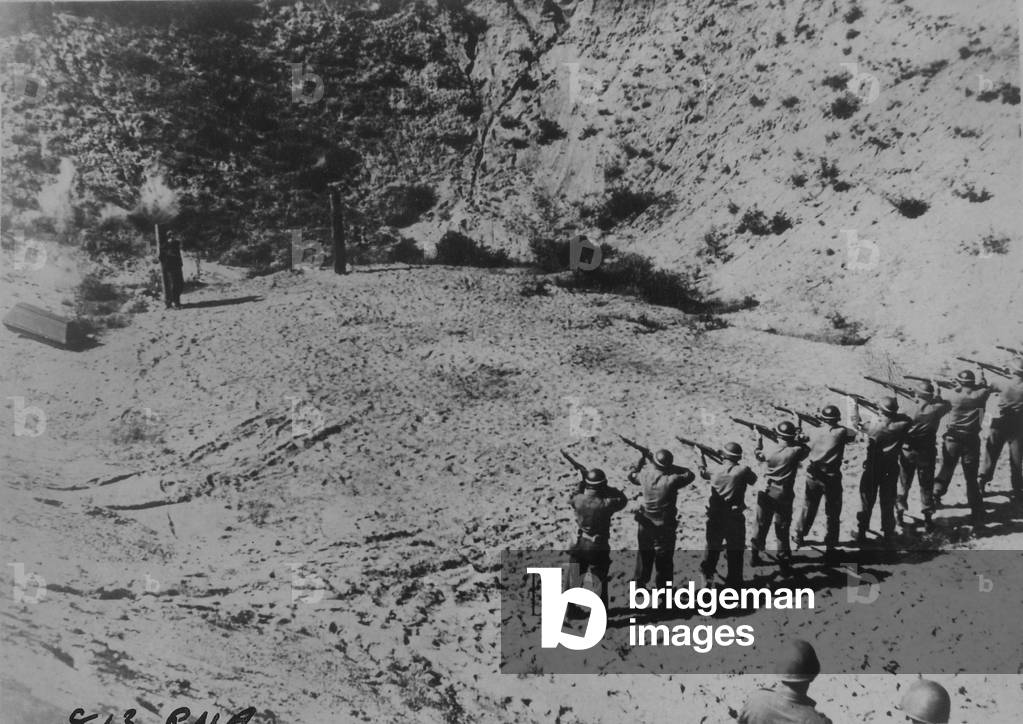 Man faces firing squad, 1942 (b/w photo) by