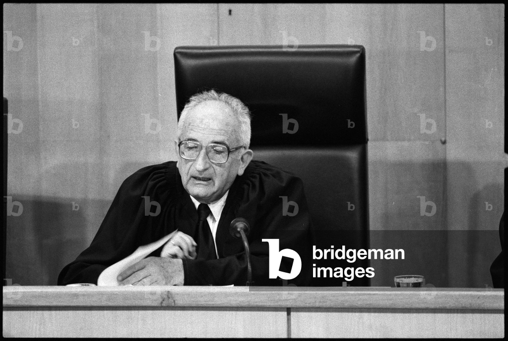Image of Presiding judge Dov Levin reads the verdict in Jerusalem in