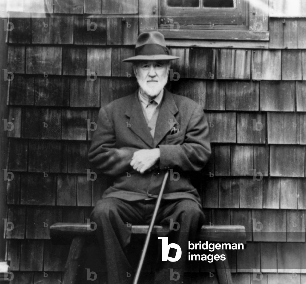 Image of Charles Ives seated with walking stick