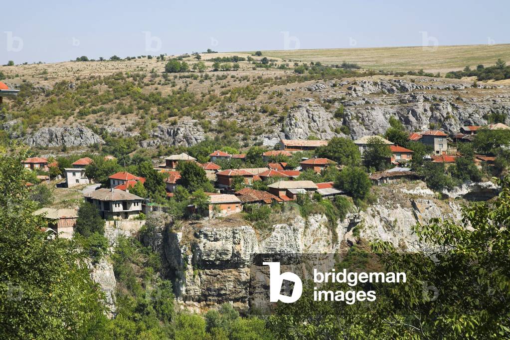 Image of Bulgaria, Cherven, rooftops of village built above rock face
