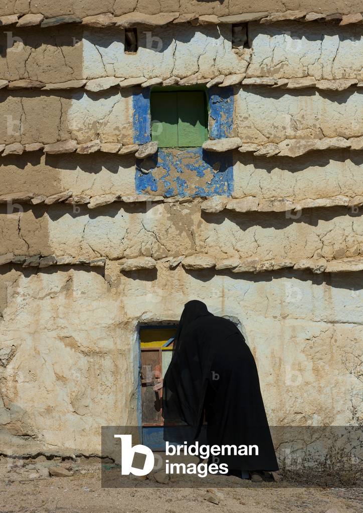 Image of Saudi Woman Going Inside Her House, Sarat Habidah, Asir, Saudi