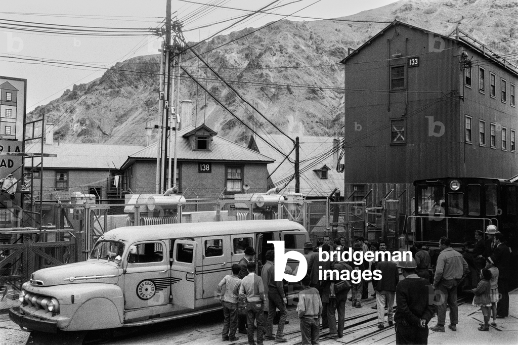 Image of Mine workers and families board a special bus to transit by ...