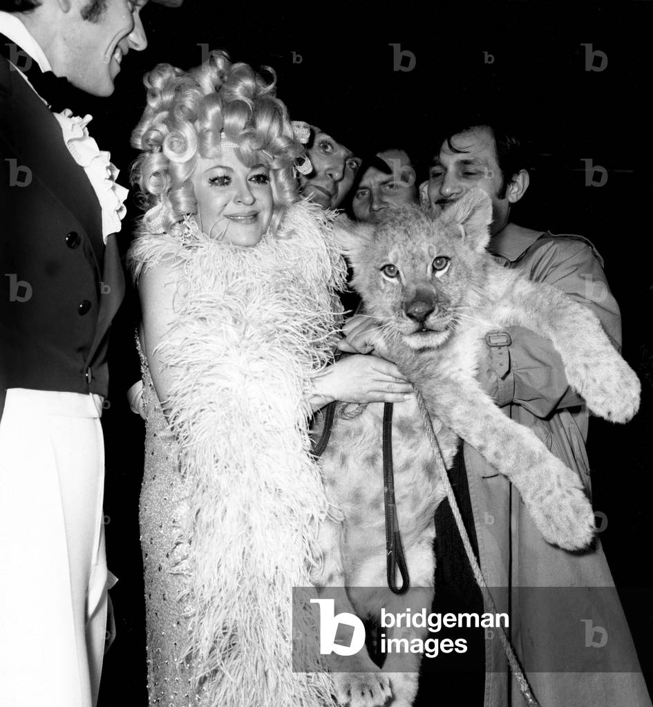 Image of Singer Regine with a lion cub celebrating the 6th Anniversary