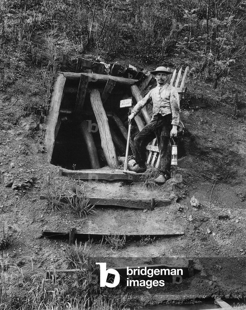 Image of Miner with his lamp, pickaxe, clogs before entering in a by ...