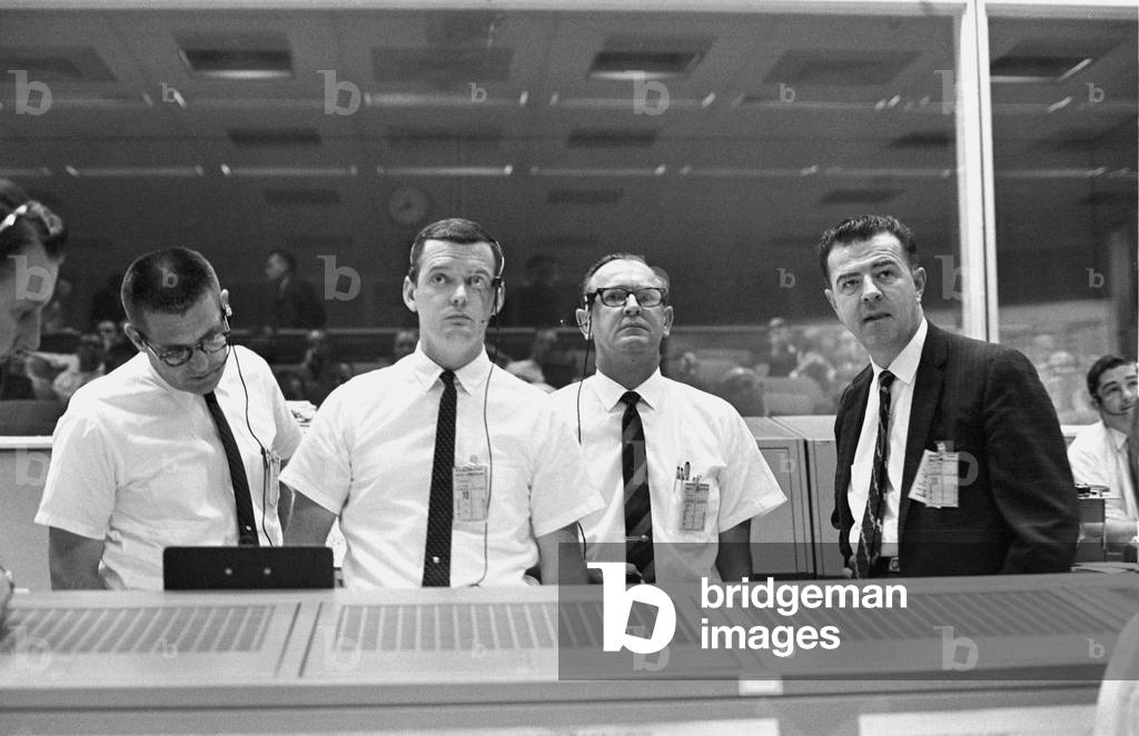 Image of Standing at the flight director's console, viewing the Gemini ...