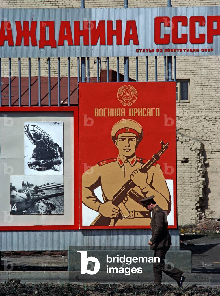 Image of Soldier walking infront of Russian Army recruitment poster ...