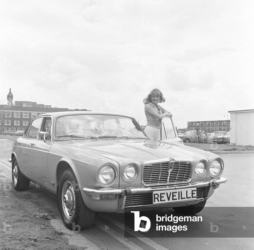 Image of Reveille model seen here posing with a Jaguar XJ12, which