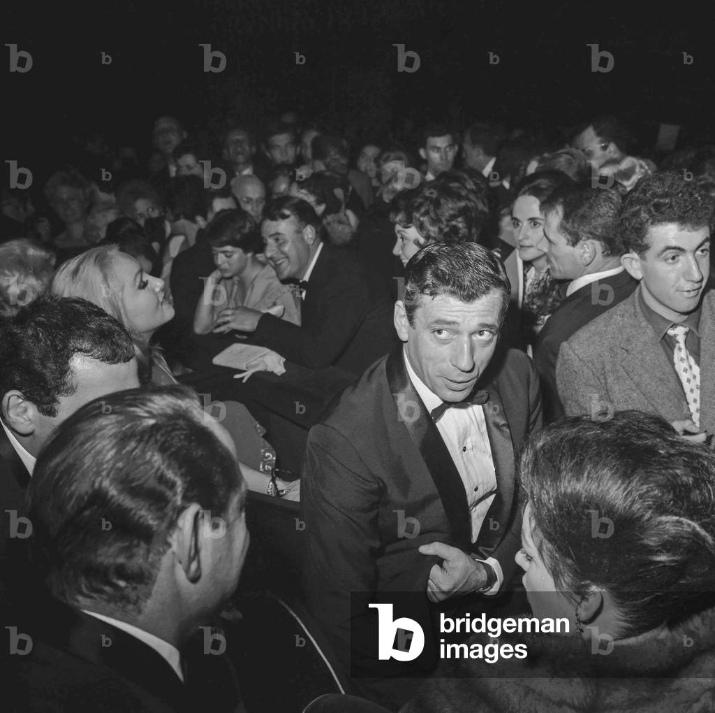 Image of French actor Yves Montand at premiere of film "Let's make