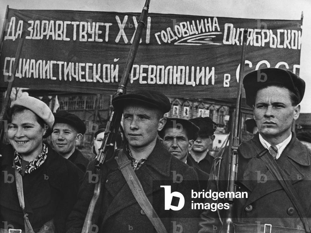 Image of Russian men and women civilians in formation, with rifles during