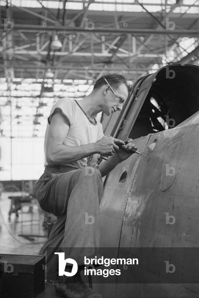 Image of Worker Riveting a Fuselage on a Sub-Assembly Line, Vultee ...