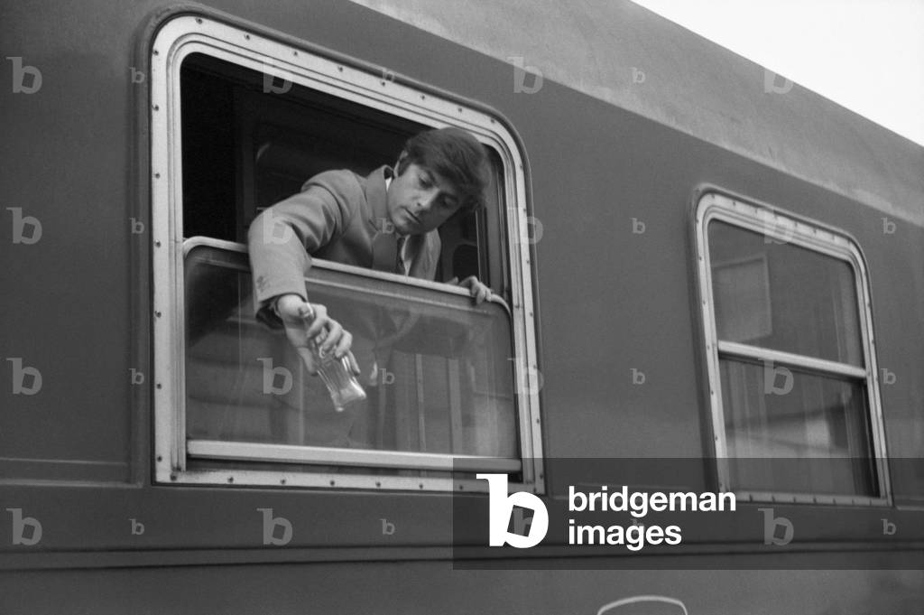 Image of A man leaning out of a train window, Italy