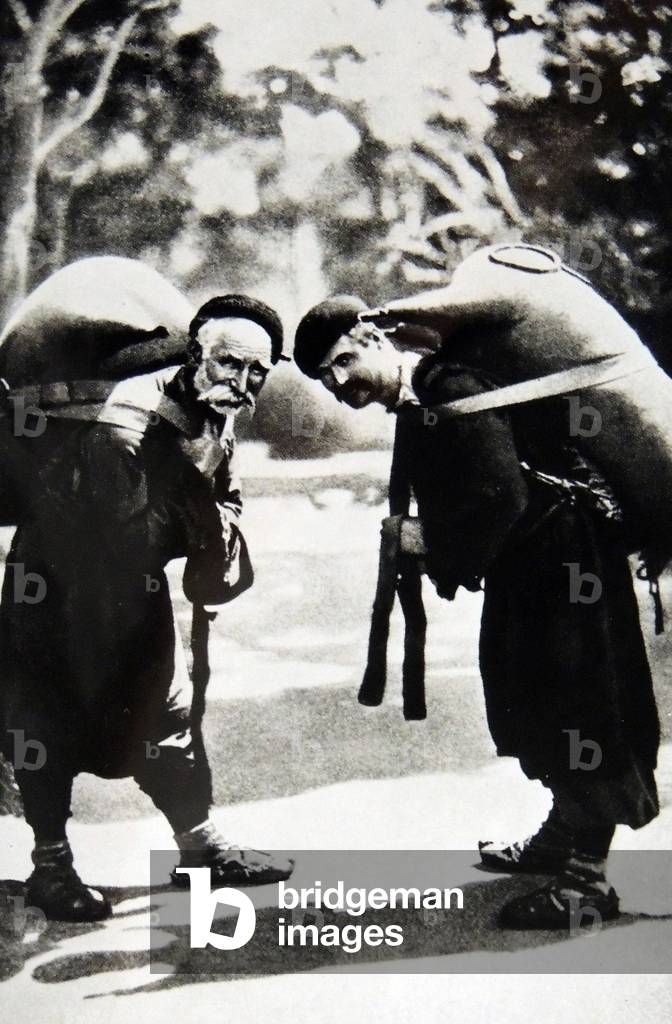 Image of Russian peasants carrying large loads circa 1900