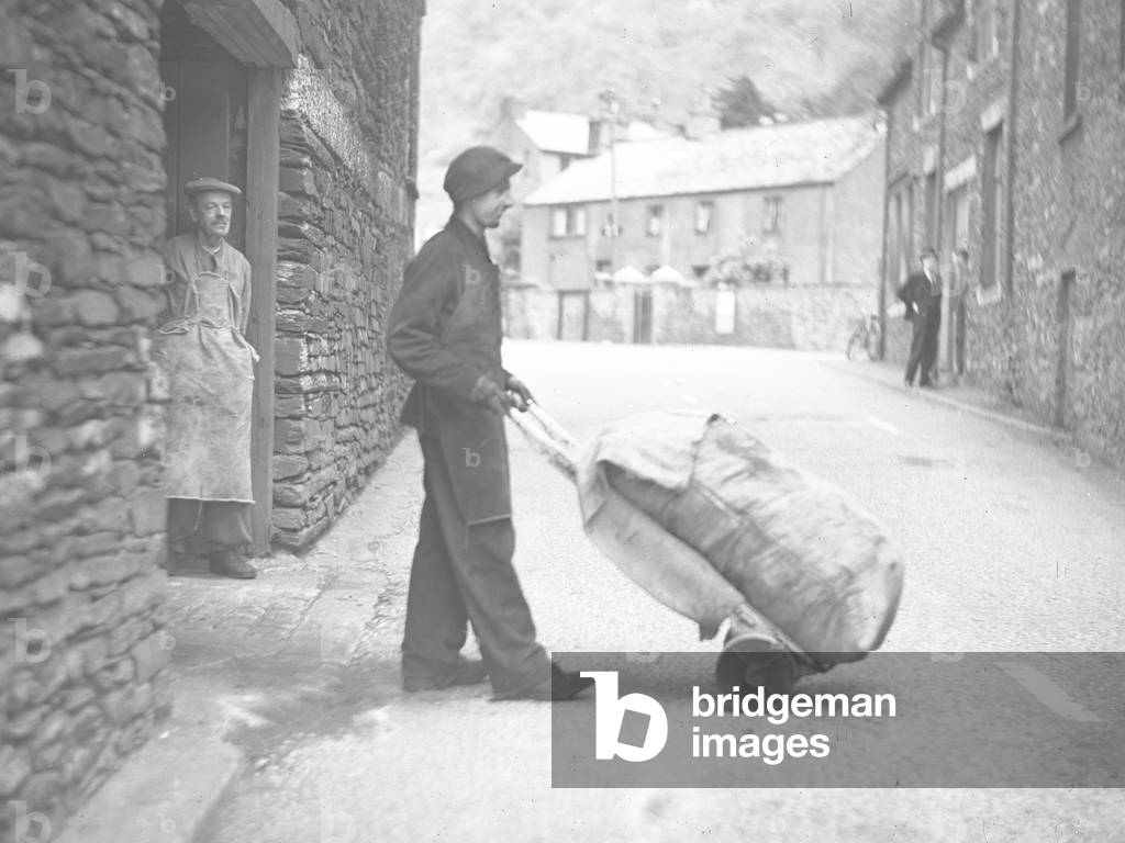 Image of A view of a coal man moving a sack of by Hardman, Joseph (1893 ...
