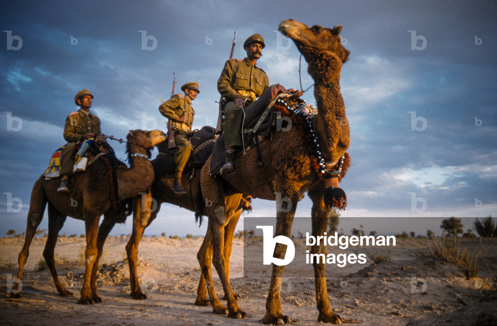 Image of Iranian soldiers patrol the desert frontier riding camels ...