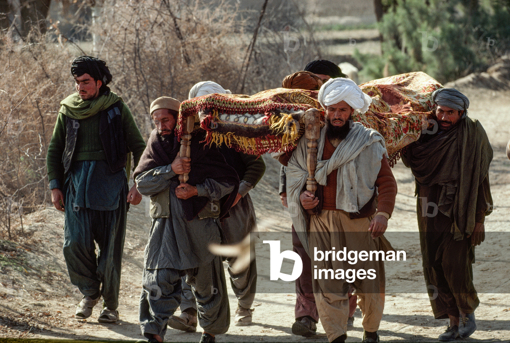 Image of An Afghan woman is taken from the refugee camp to by Stanfield ...