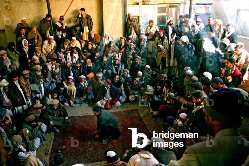 Image of Afghan men gathered at a private house where Bird fighters