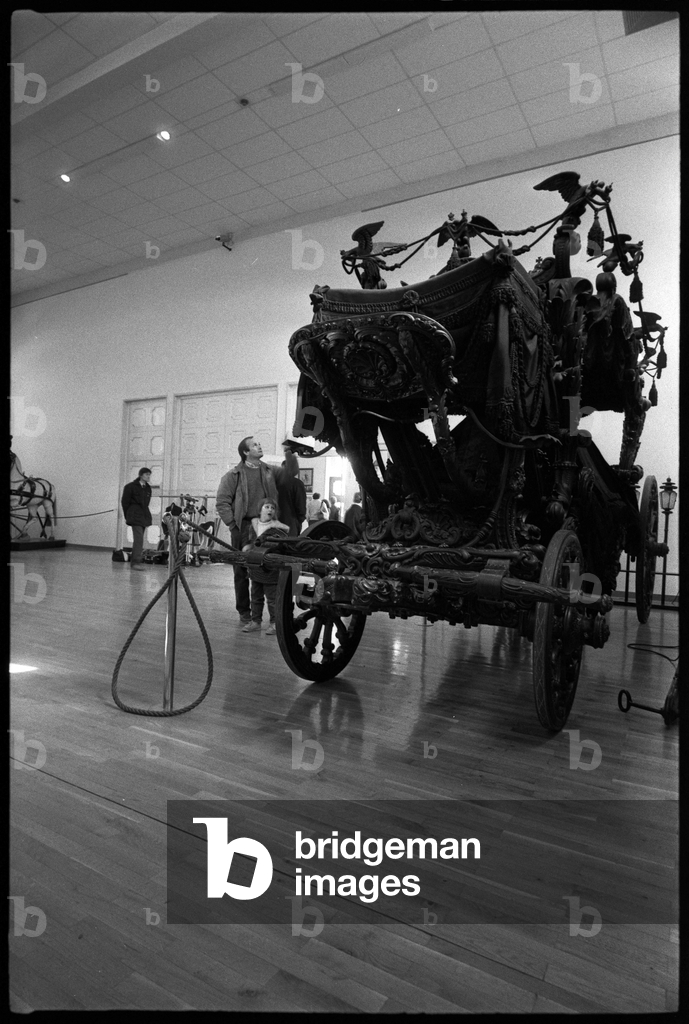 Image of A father shows his daughter the black carriage that will by ...