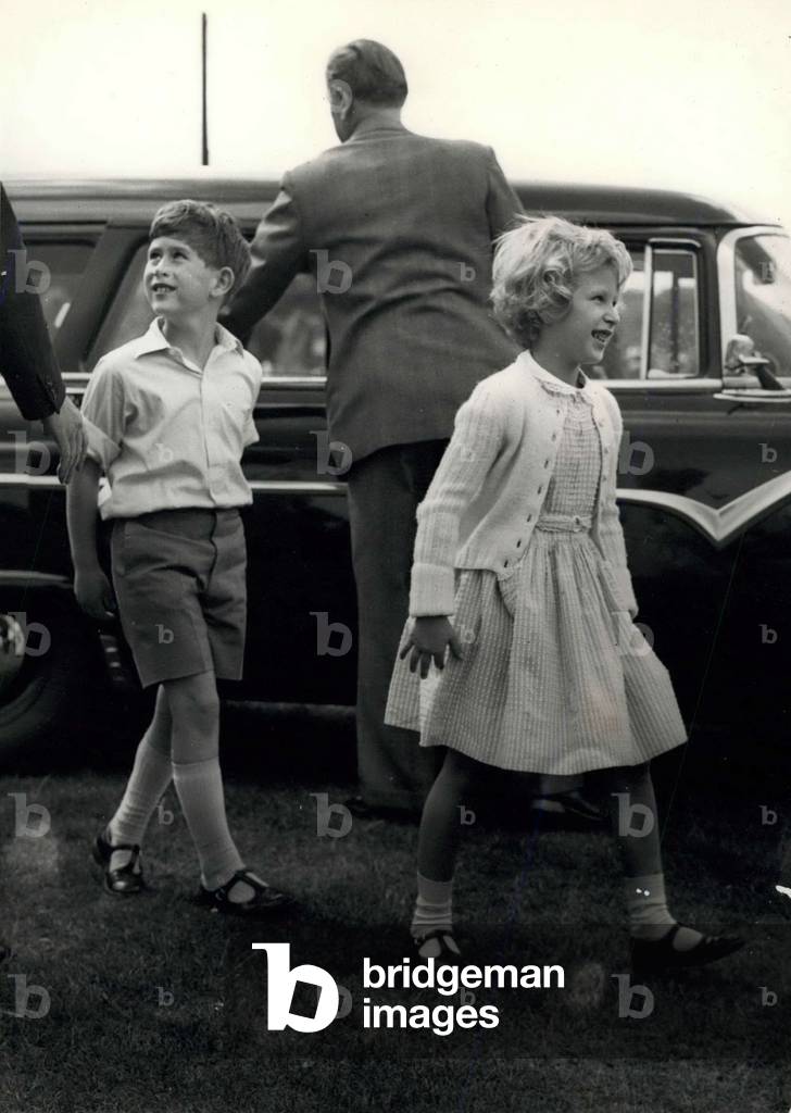 Image of Prince Charles (left) and Princess Anne smile as they arrive