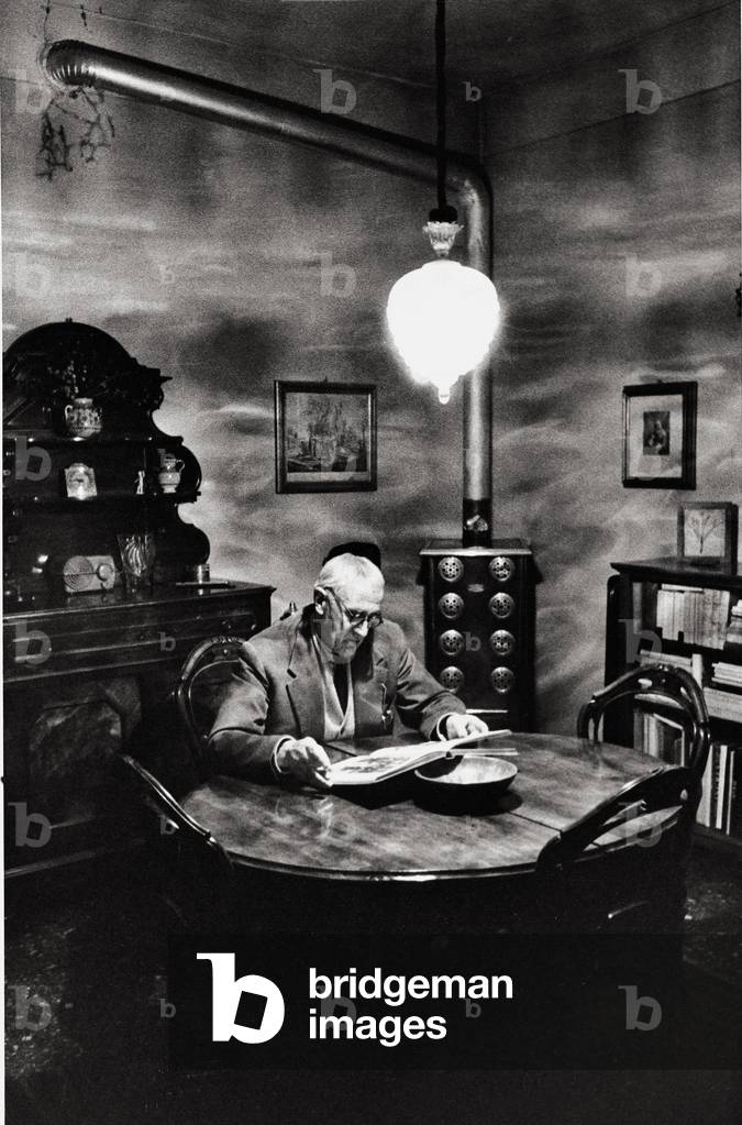 Image of Giorgio Morandi reading a book, Italy, 1959 (b/w photo)