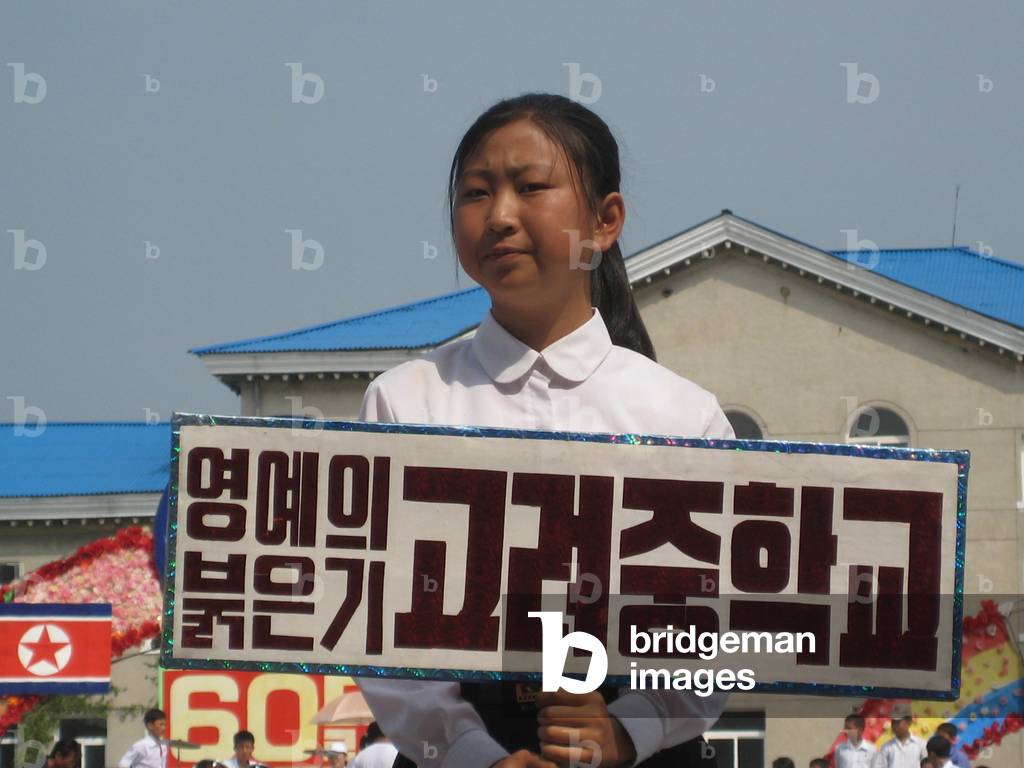 Image of Schoolgirl holding propaganda placard at the celebrations of ...