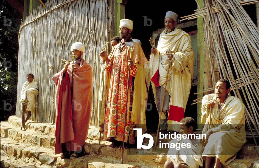 Image of Coptic priests on the steps of their round church, Zeghi