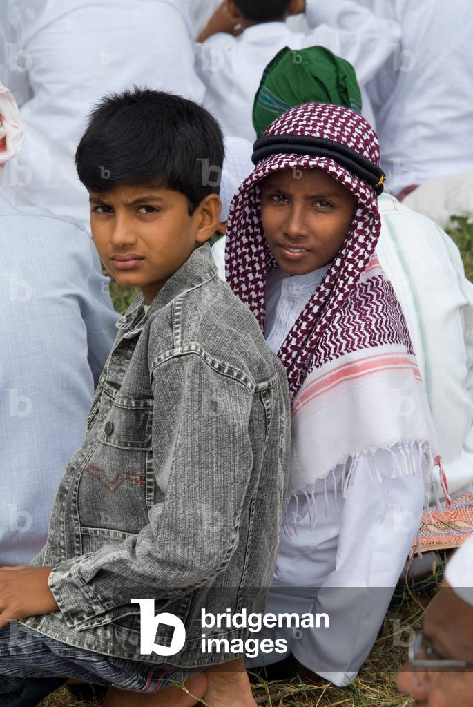 Image of Islam: Two Muslim boys in traditional and modern dress at