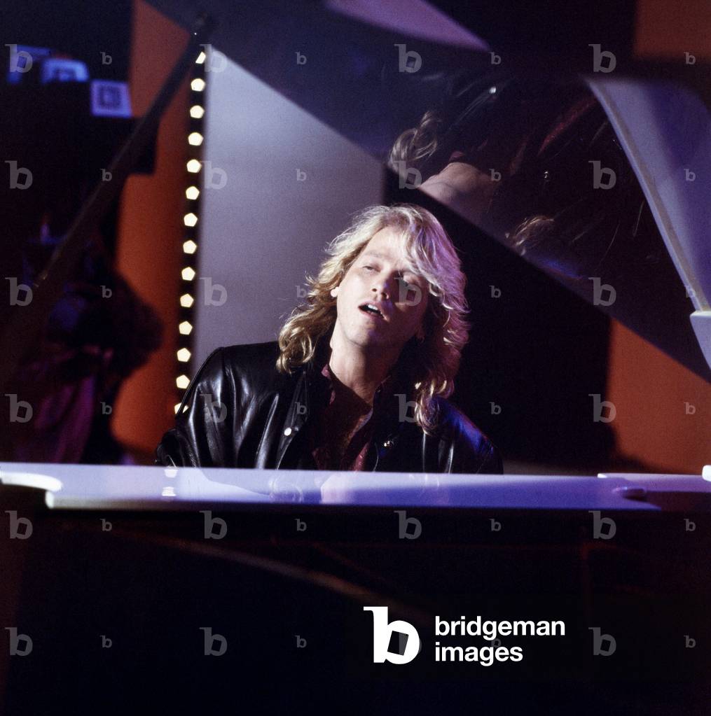 Image of American songwriter, producer and singer Mark Spiro sits at a