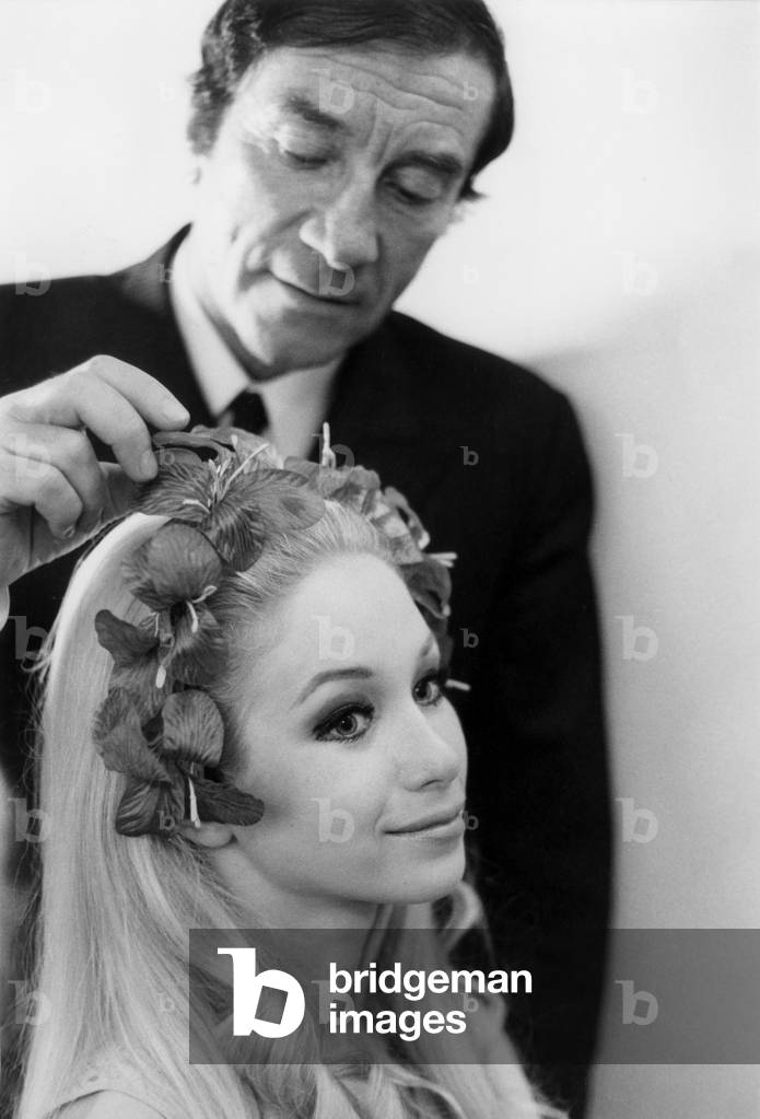 Image of Jean D'Estrees Putting An Hairband on Head of Actress Lyne