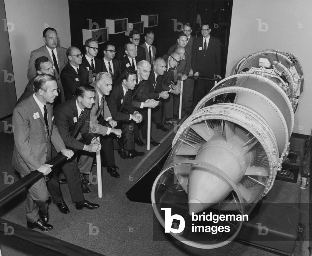 Image of A Group Of Men In Suits Looking At A Jet