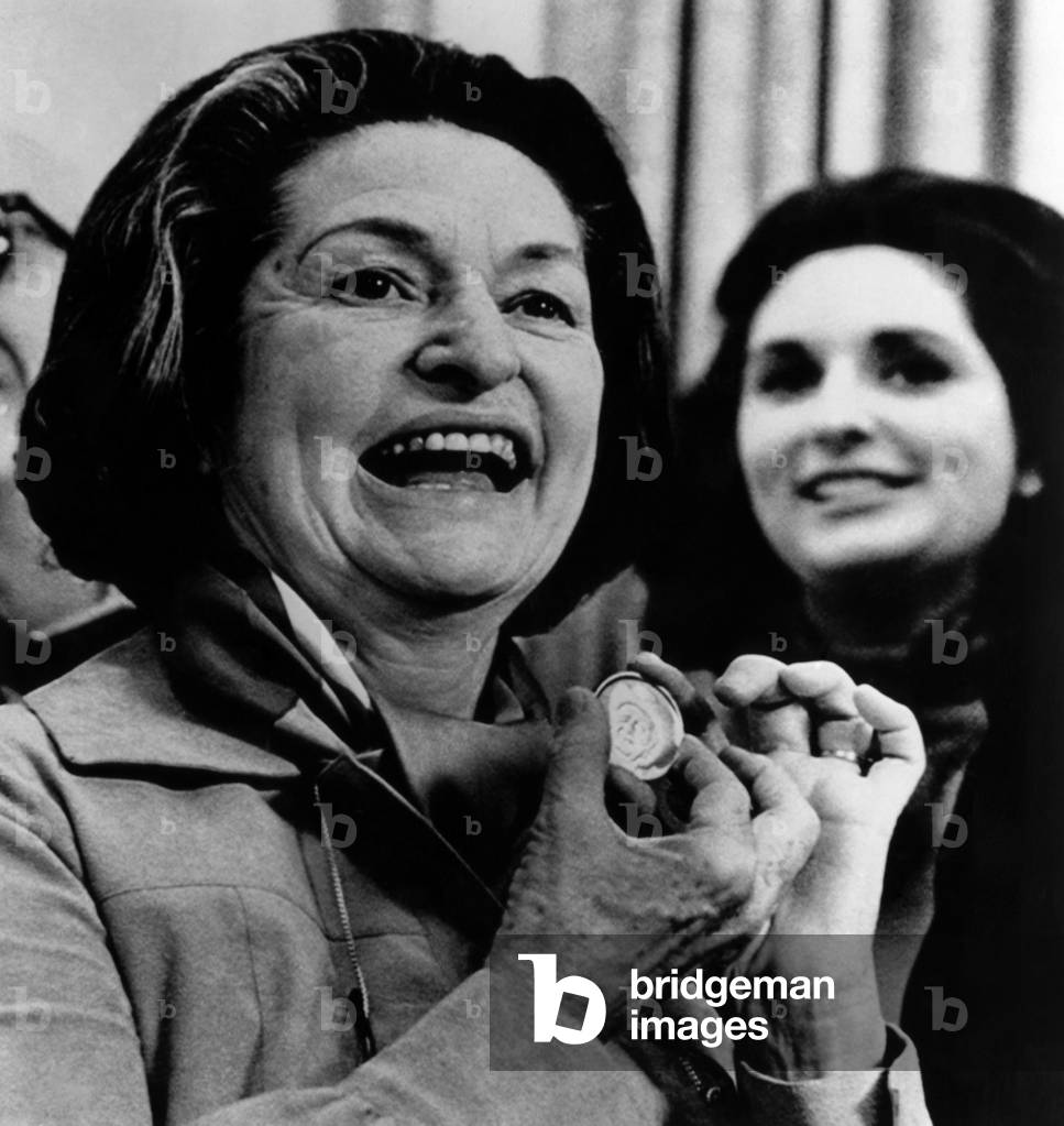 Image of Lady Bird Johnson displaying an 18 karat gold medal honoring