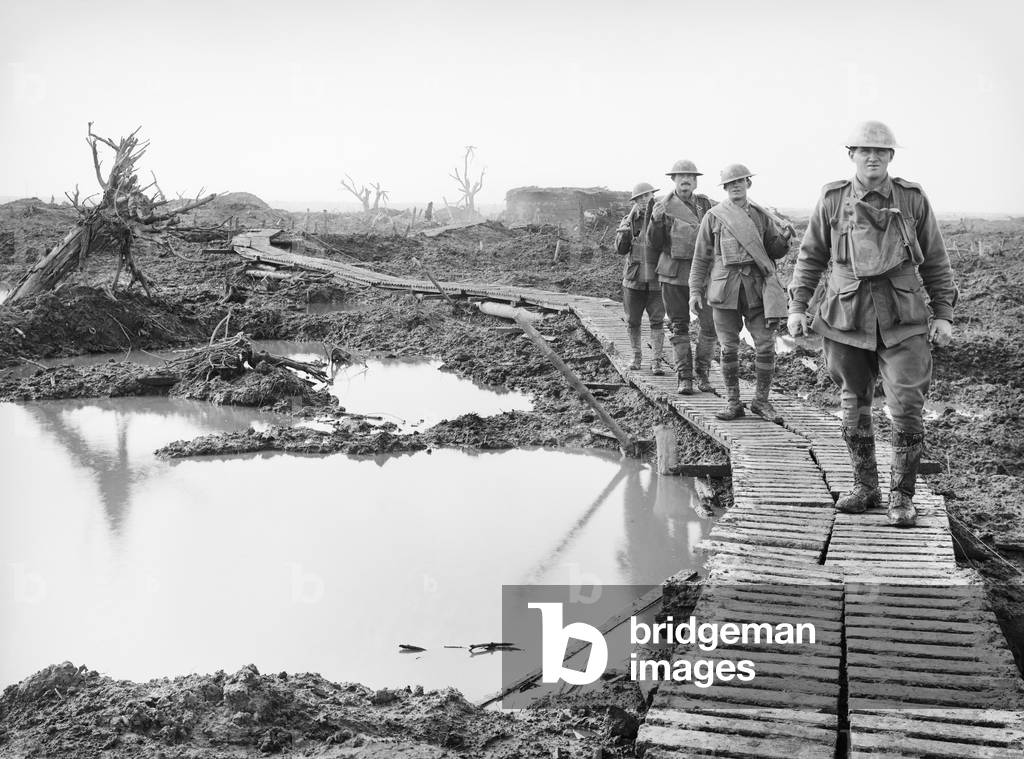 Image of Four Australian soldiers walking along the duckboard track at ...