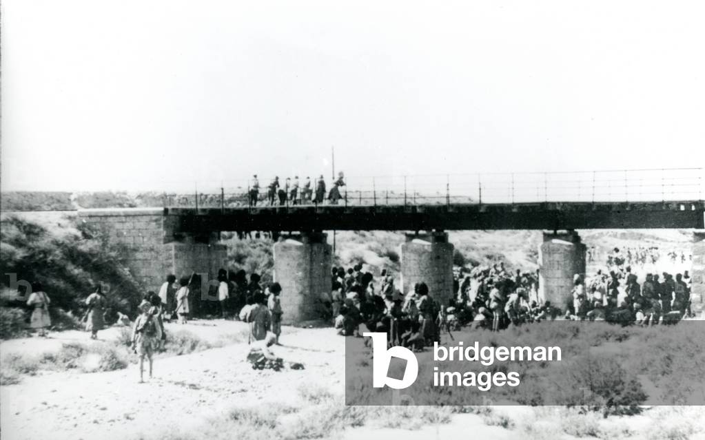 Crowd of men on and around the Railway bridge at Khaaka, Turkmenistan ...