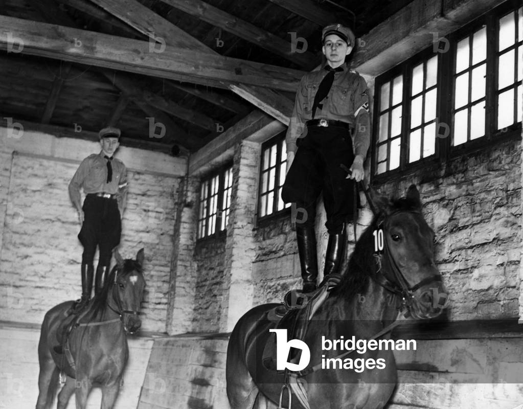 Image of Hitler Youth members stand on their horses, 1938 (b/w photo)