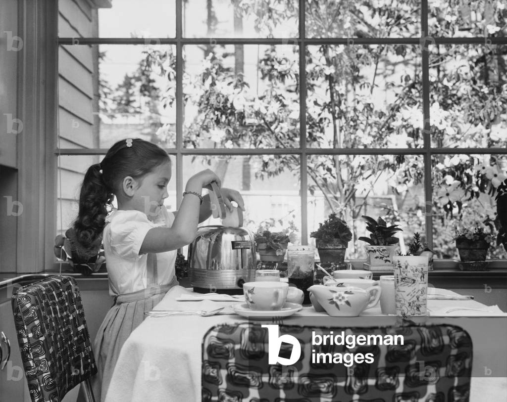Image of Side profile of a girl making toast