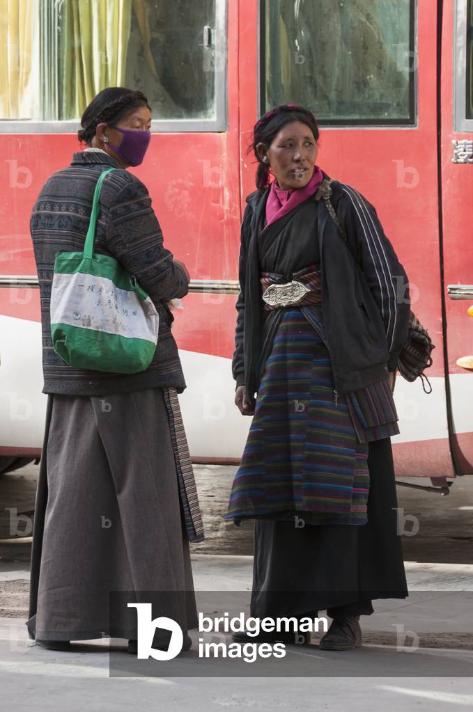 Image of Two local women on Xigaze downtown, wearing part of the
