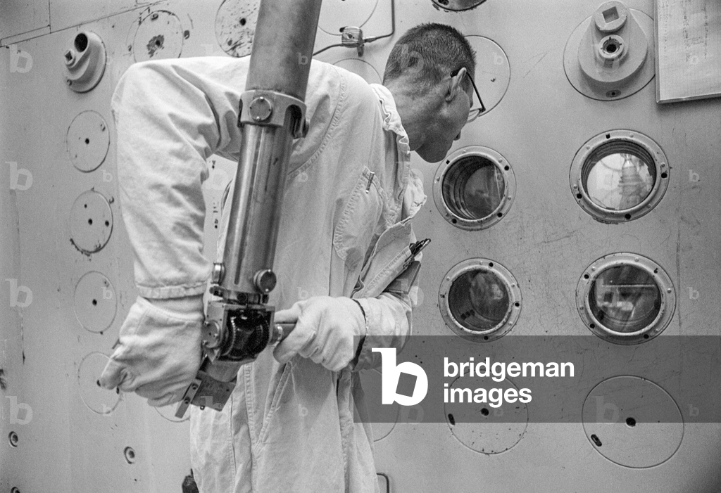 Image of Technician handles radioactive materials using remote handling ...