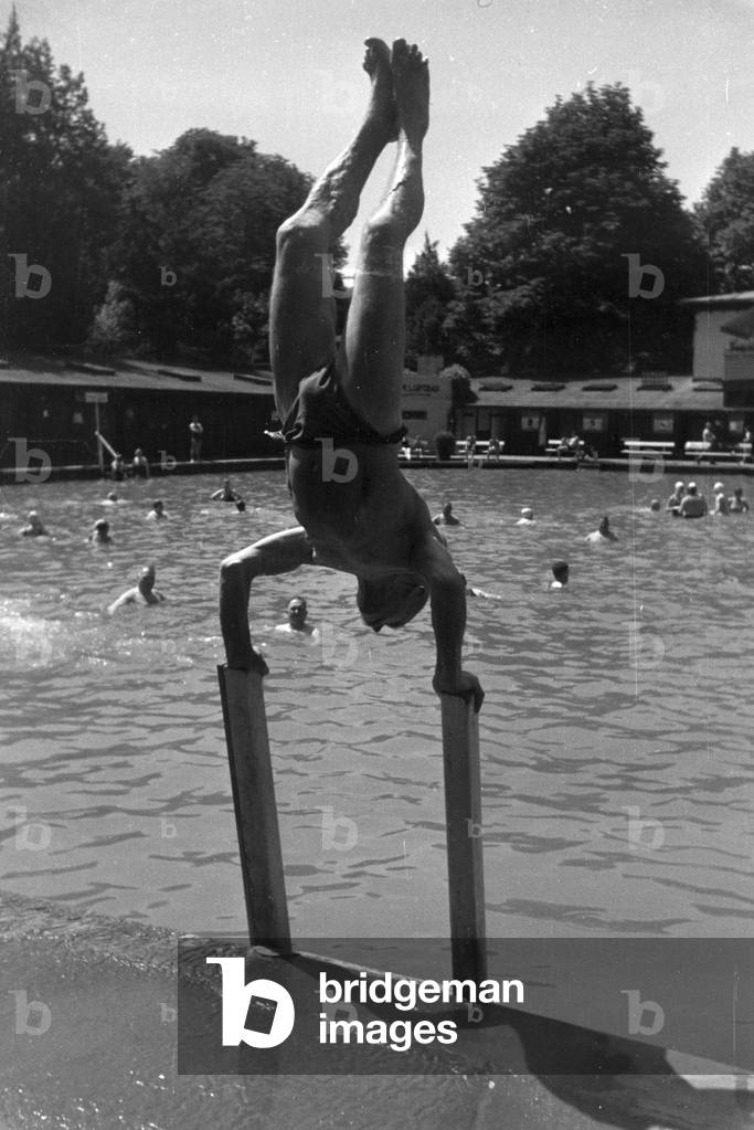 Image of A bather pulling off acrobatic feats in an open air