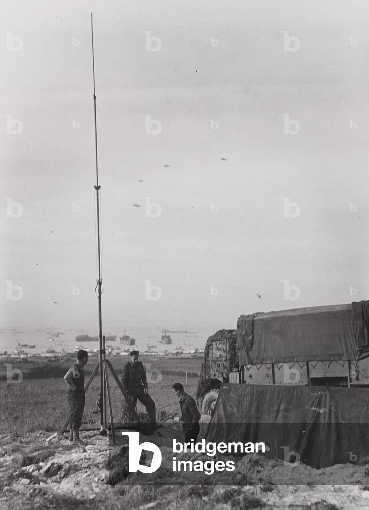 Image of A signals unit erecting a radio mast on one of by Unknown ...