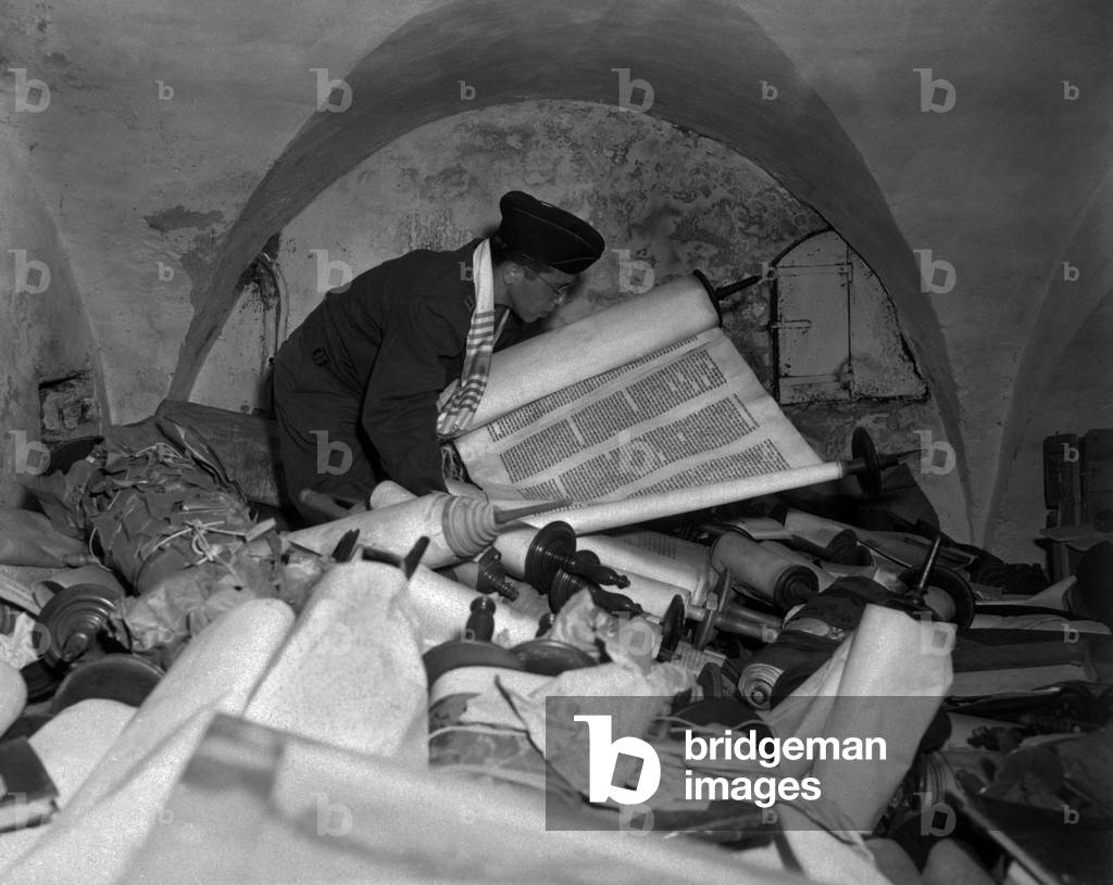 Image of US Army Jewish Chaplain examines torahs stolen by Nazis. July