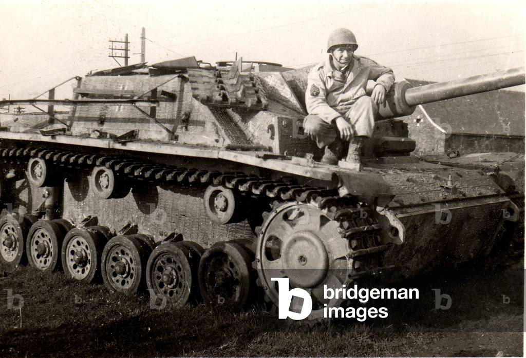 Image of GI sits on a captured German self-propelled Gun