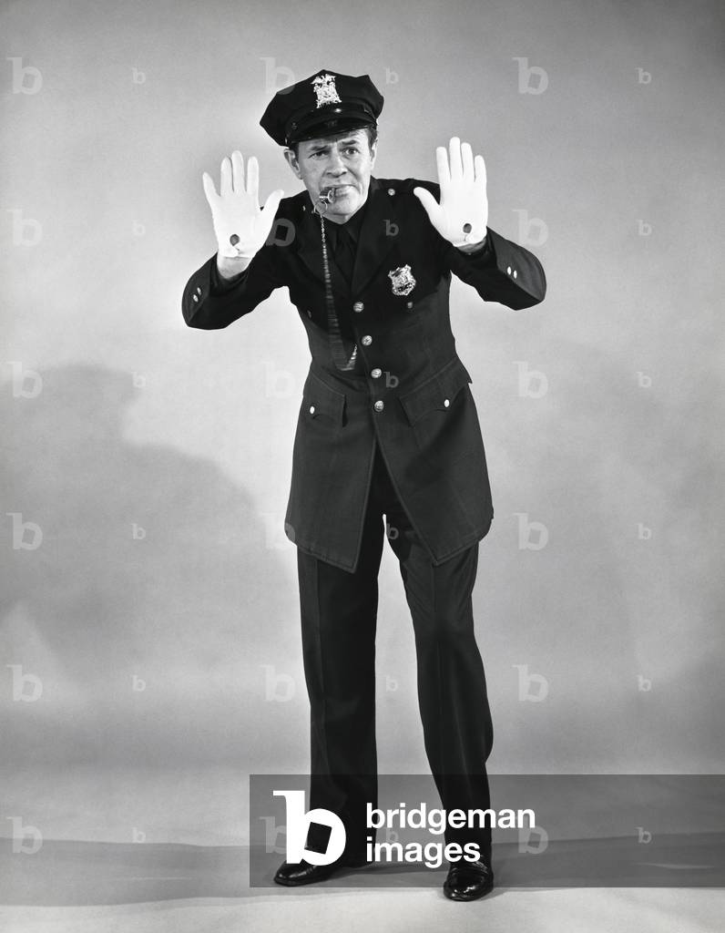 Police officer making a stop gesture by