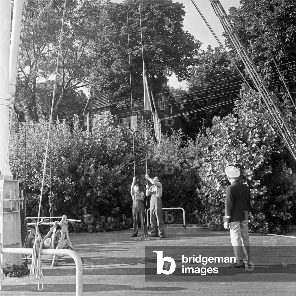 Image of Flying the flag in front of Captain Ernst Wagner, director