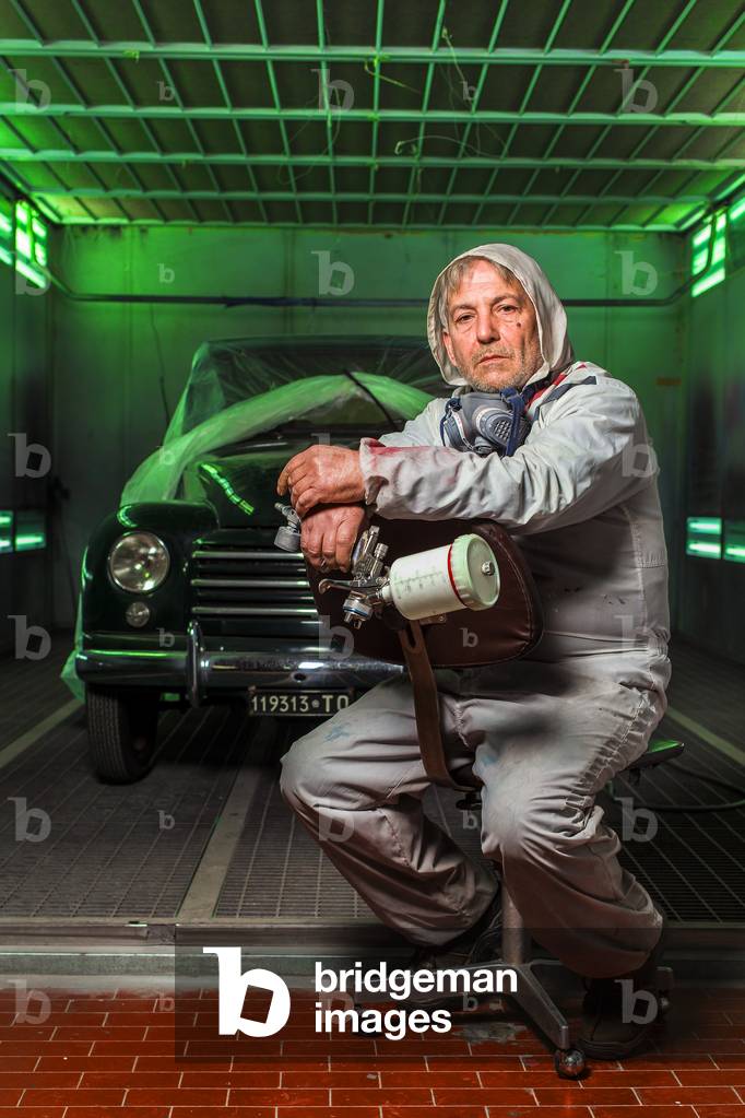Image of A Turin coachbuilder poses for a portrait in front of by ...